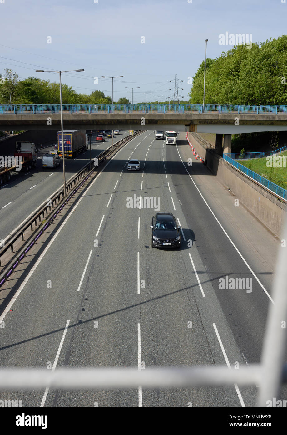 Traffic on M60 motorway at junction 17 passing under A56 road in ...