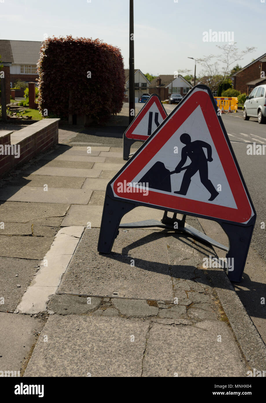 Triangular roadworks sign on damaged pavement in bury lancashire uk ...