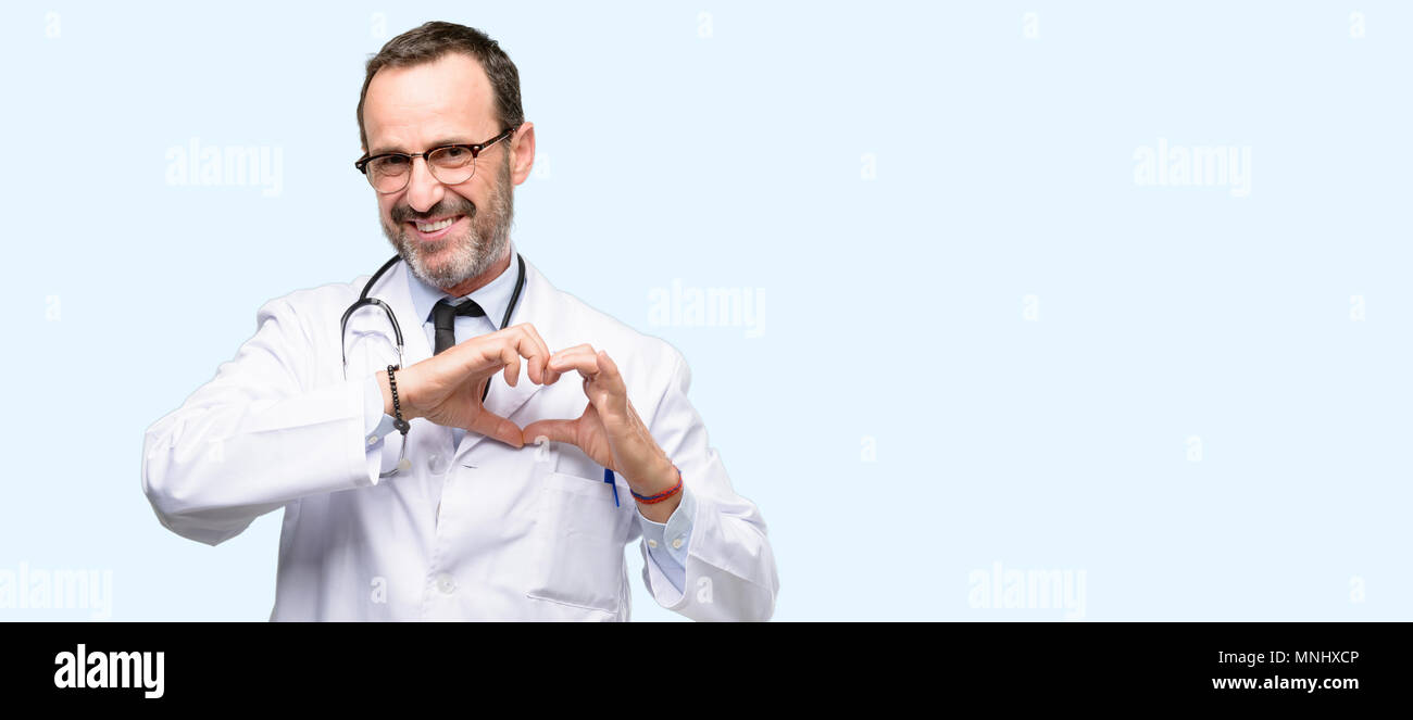 Doctor senior man, medical professional happy showing love with hands ...