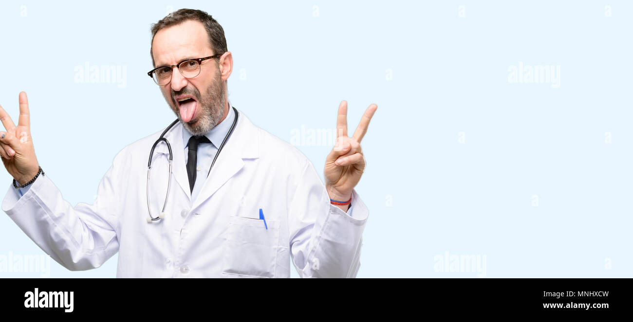 Doctor senior man, medical professional looking at camera showing tong ...