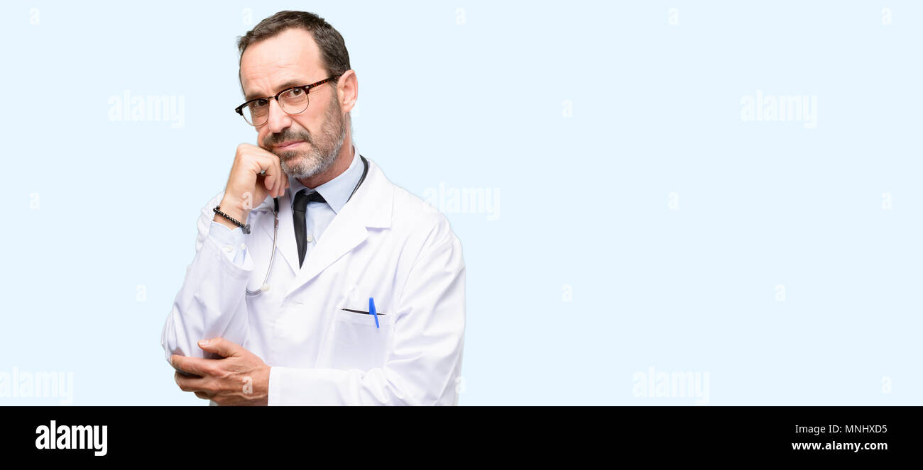 Doctor senior man, medical professional thinking and looking up ...