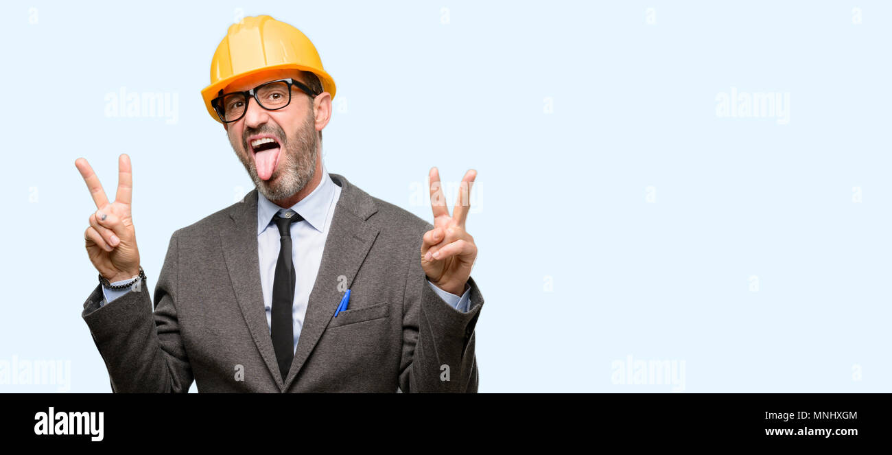 Senior architect or engineer looking at camera showing tong and making ...