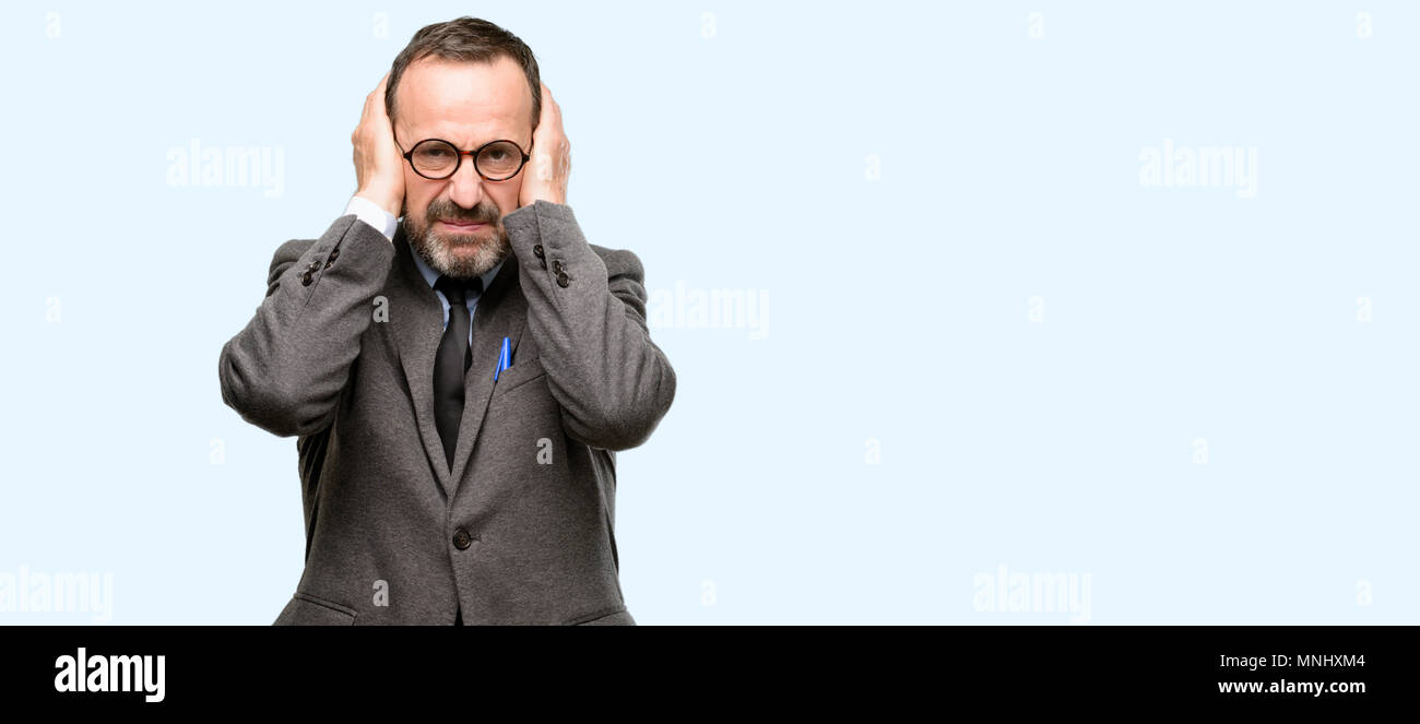Teacher man using glasses covering ears ignoring annoying loud noise ...