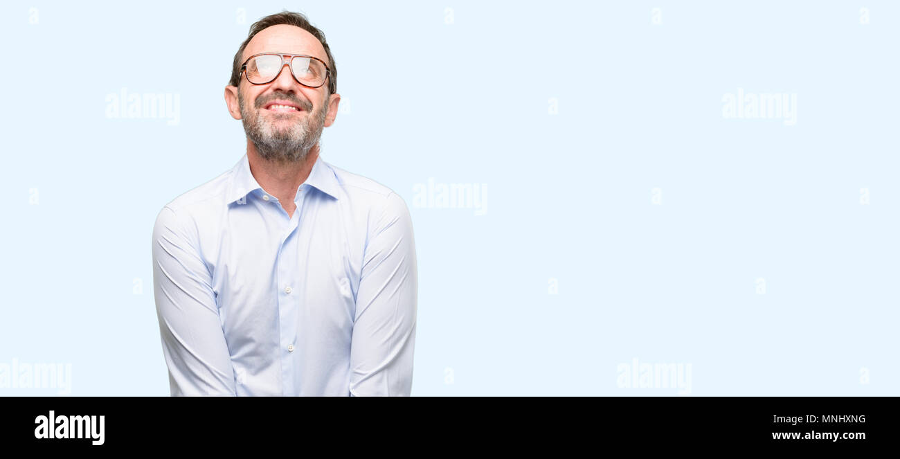 Middle age man with glasses thinking and looking up expressing doubt ...