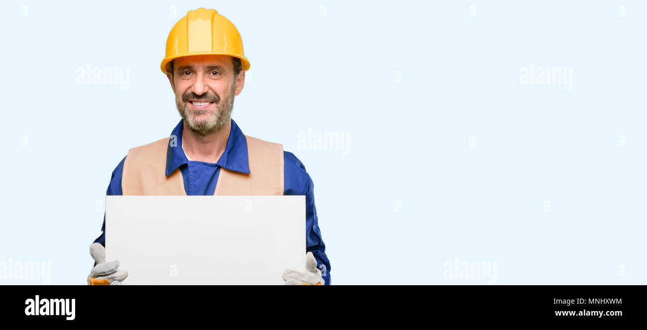 Senior engineer man, construction worker holding blank advertising ...