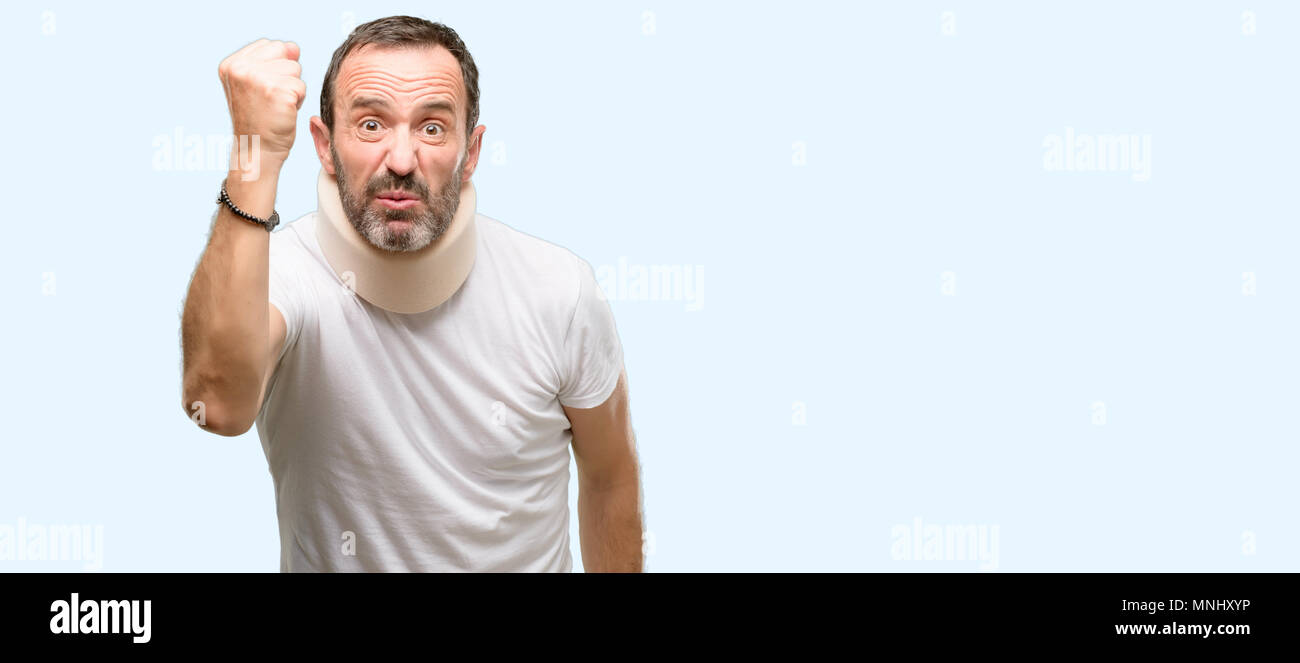 Injured senior man using a neck brace irritated and angry expressing ...