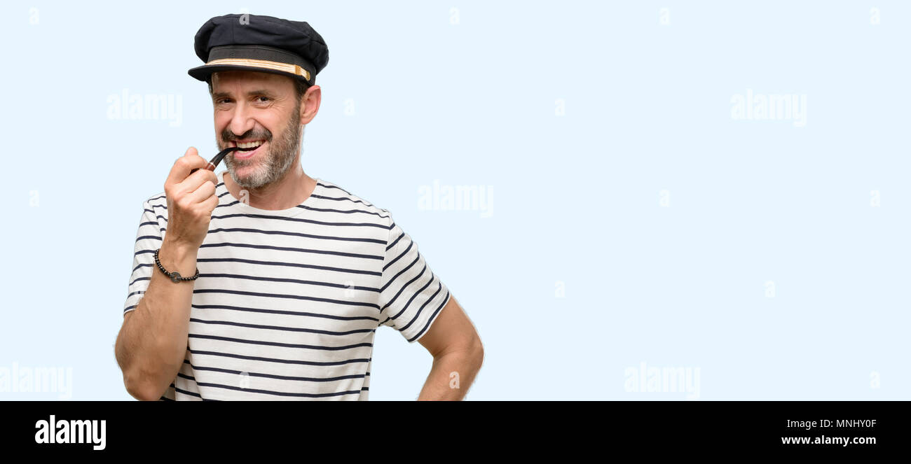 Sailor captain man smoking a tobacco pipe confident and happy with a ...