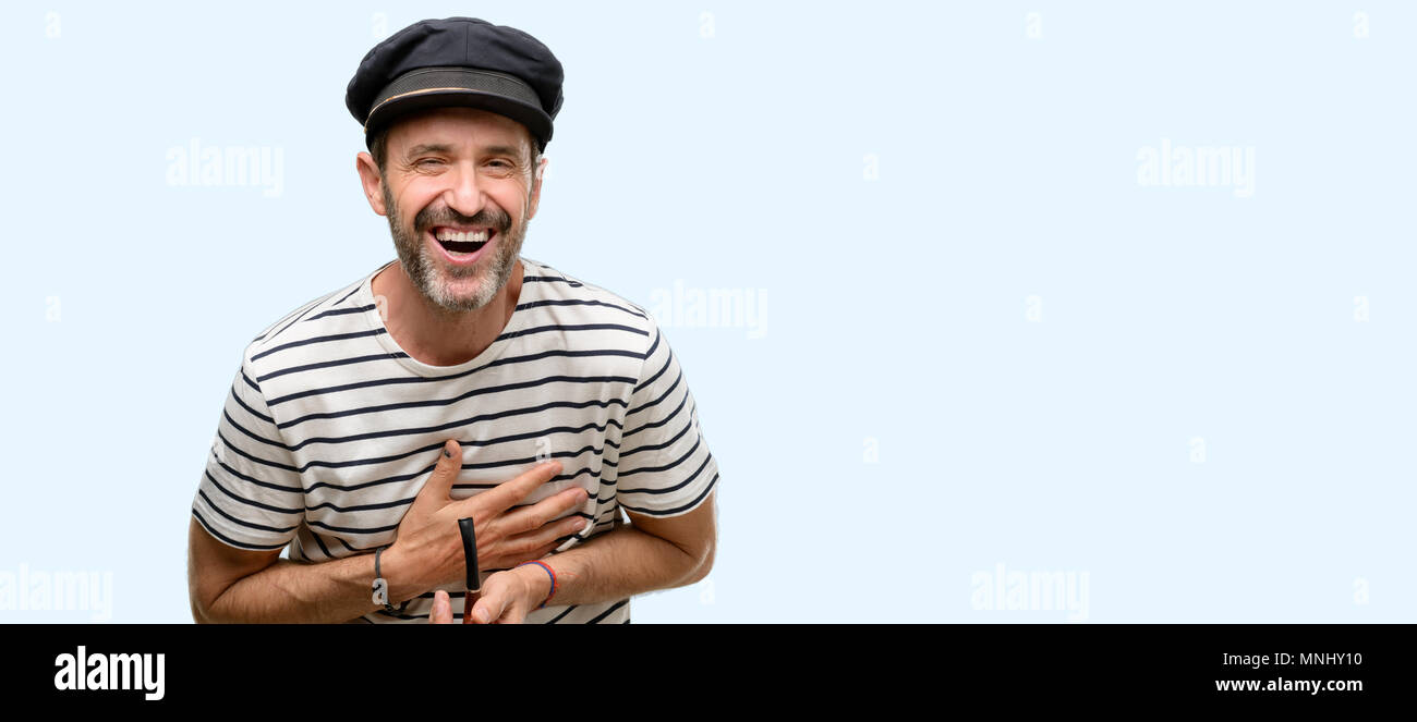 Sailor captain man smoking a tobacco pipe confident and happy with a ...