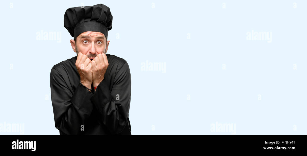 Senior cook man, wearing chef hat terrified and nervous expressing ...