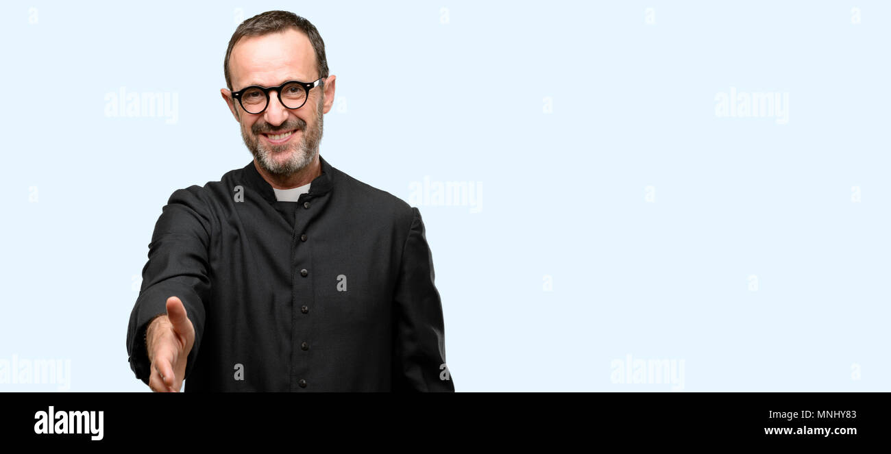 Priest religion man holds hands welcoming in handshake pose, expressing ...