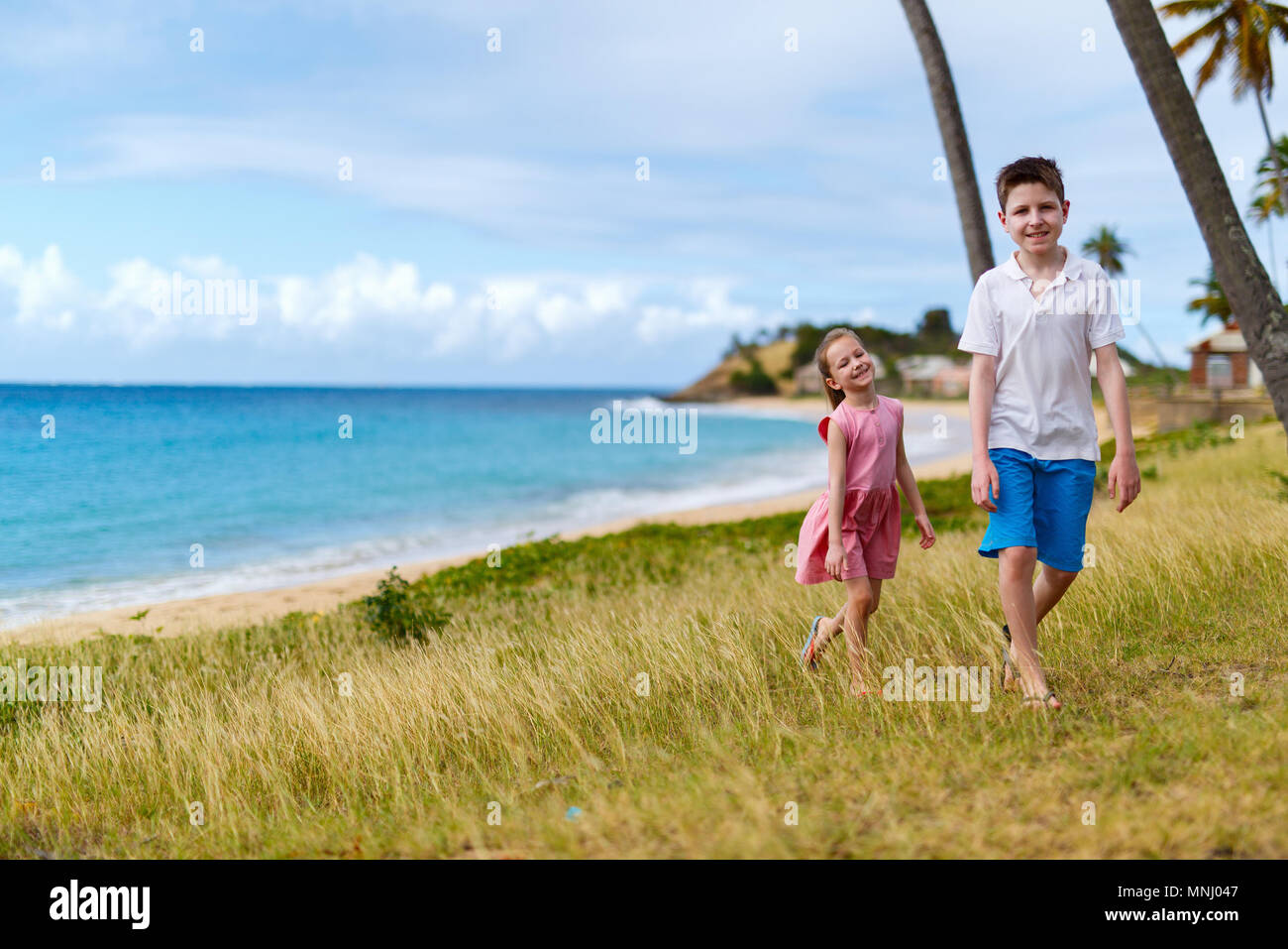 Kids exploring tropical beach during summer vacation Stock Photo - Alamy