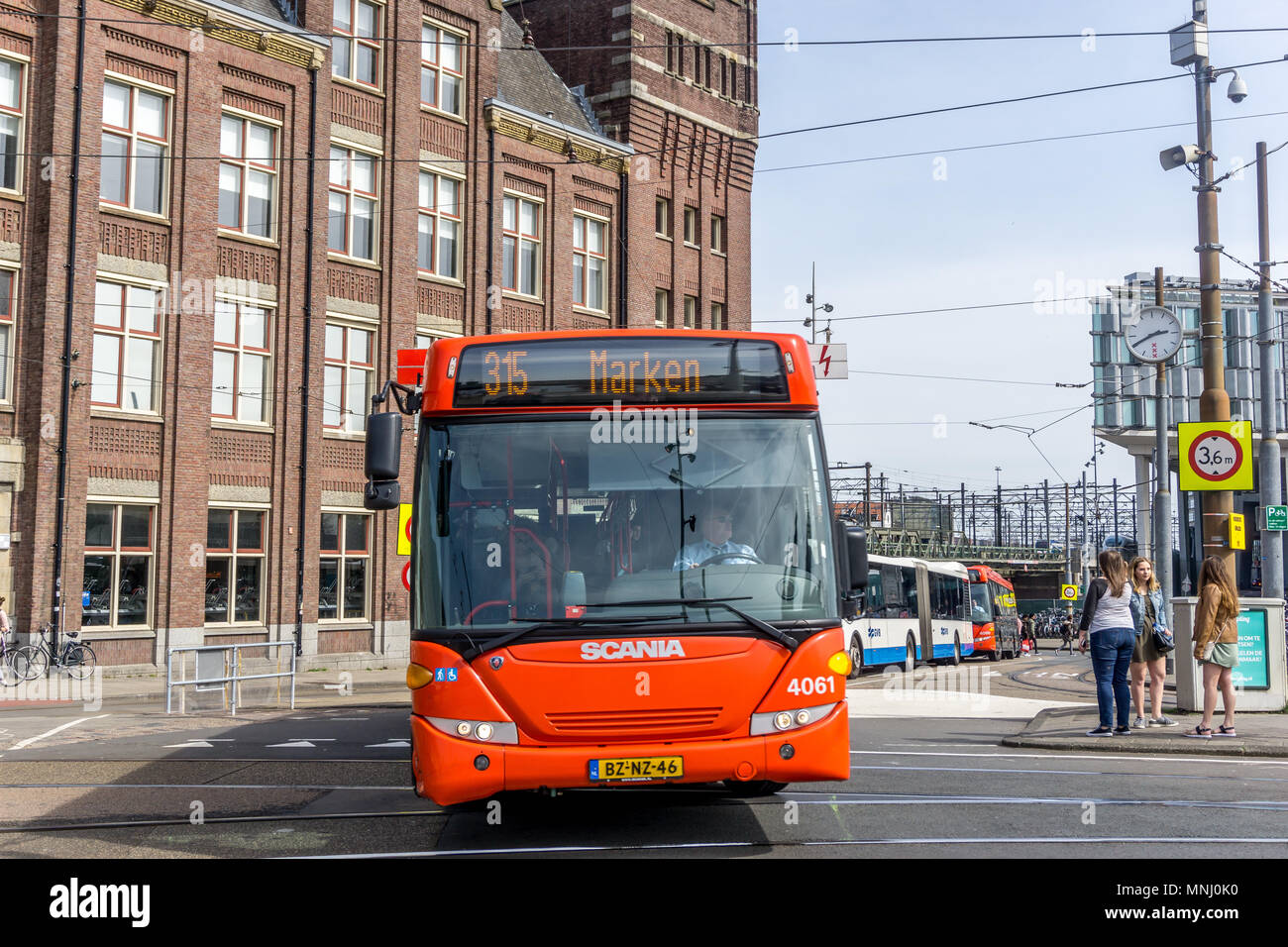 Bus and trams travelling on Stationsplein, Amsterdam, Netherlands ...