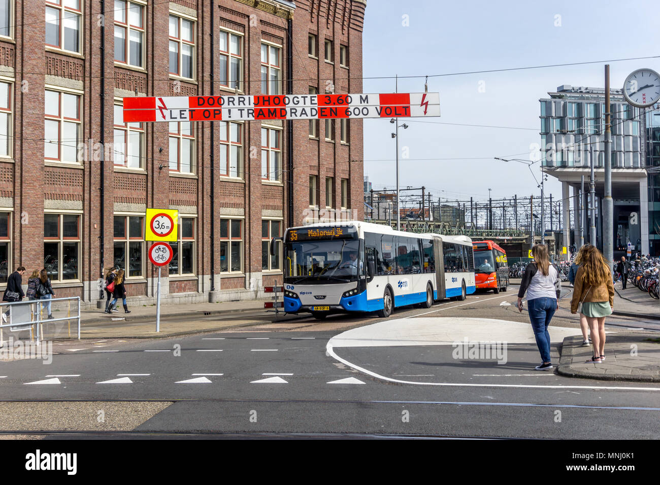 Bus and trams travelling on Stationsplein, Amsterdam, Netherlands ...