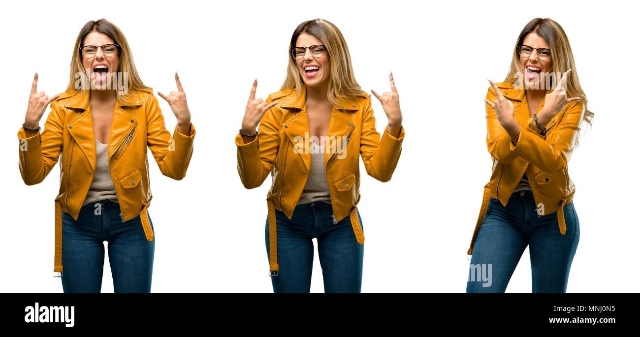 Beautiful young woman making rock symbol with hands, shouting and ...