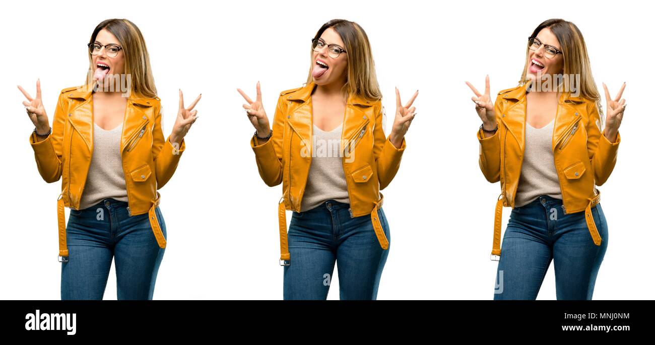 Beautiful young woman looking at camera showing tong and making victory ...