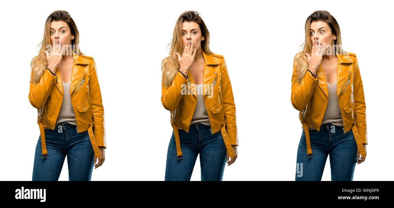 Beautiful young woman covers mouth in shock, looks shy, expressing ...