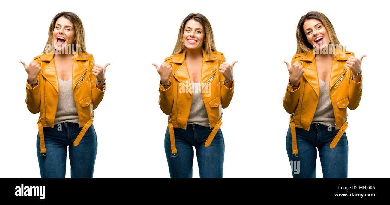 Beautiful young woman smiling broadly showing thumbs up gesture to ...