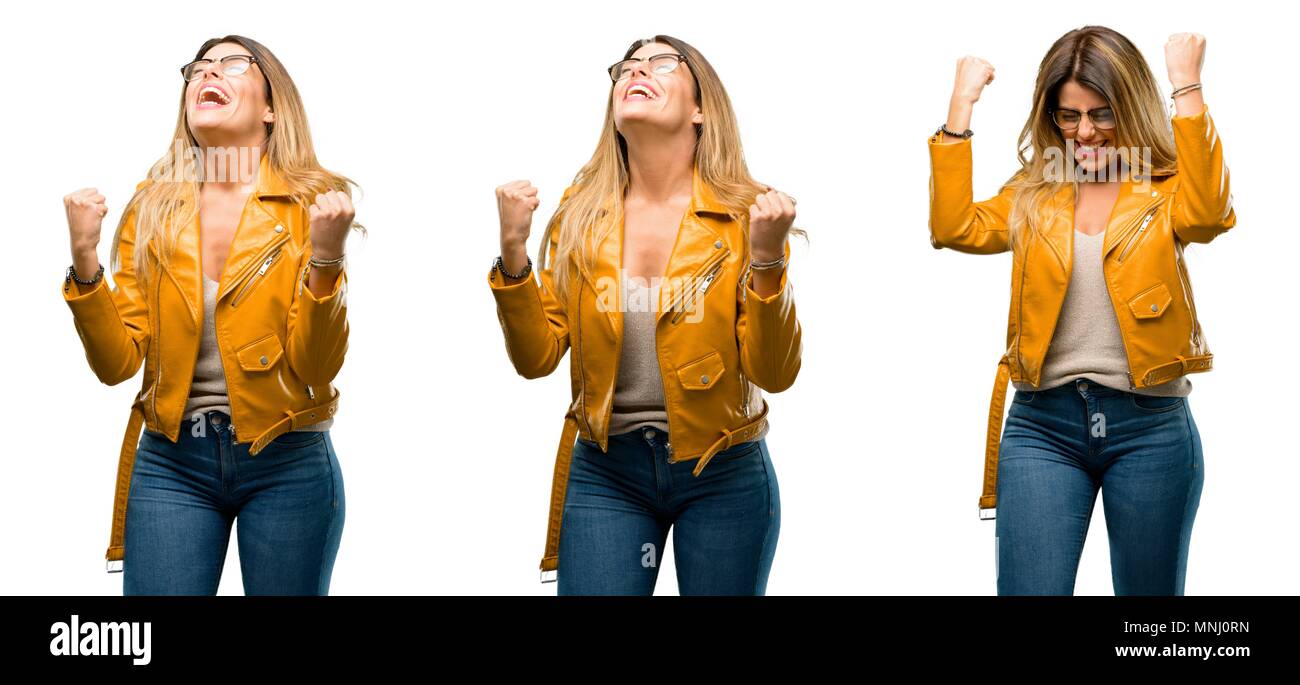 Beautiful young woman happy and excited expressing winning gesture ...