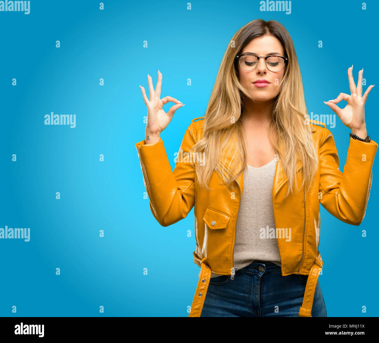 Beautiful young woman doing ok sign gesture with both hands expressing ...