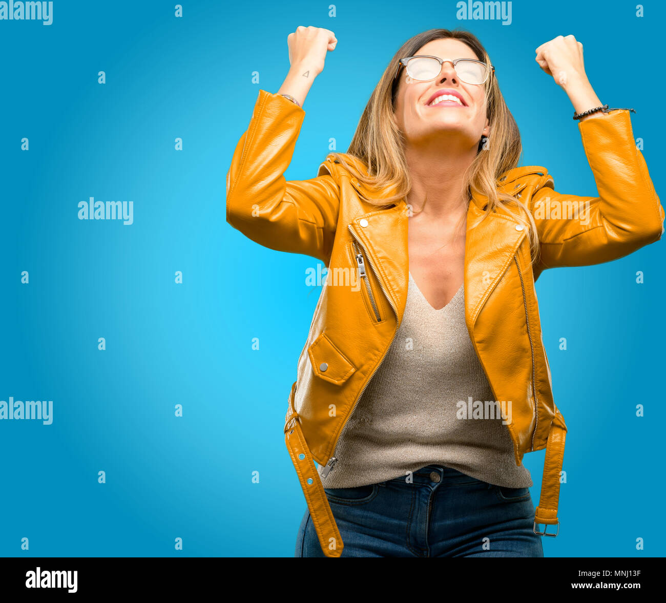 Beautiful young woman happy and excited expressing winning gesture ...
