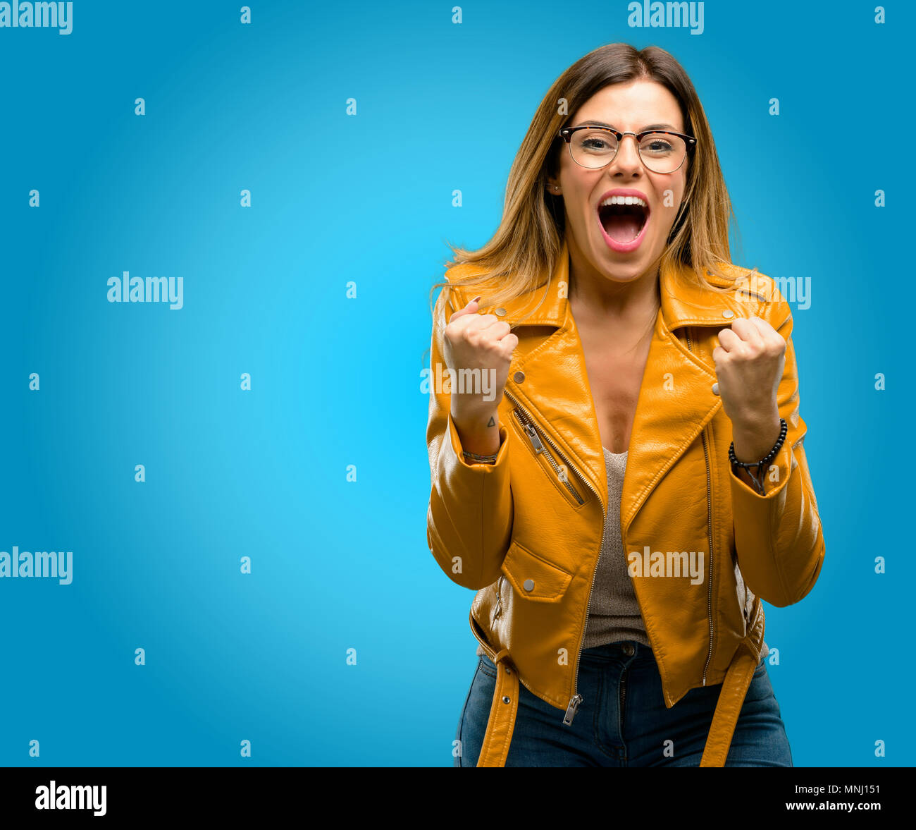 Beautiful young woman happy and excited expressing winning gesture ...