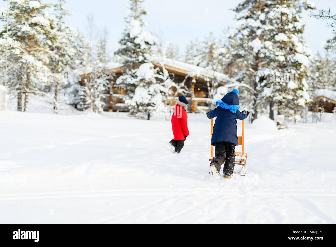 Back view of little girl and cute boy outdoors on beautiful winter day ...