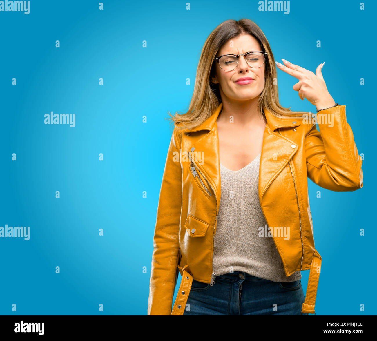 Beautiful young woman unhappy making suicide gesture, tired of ...