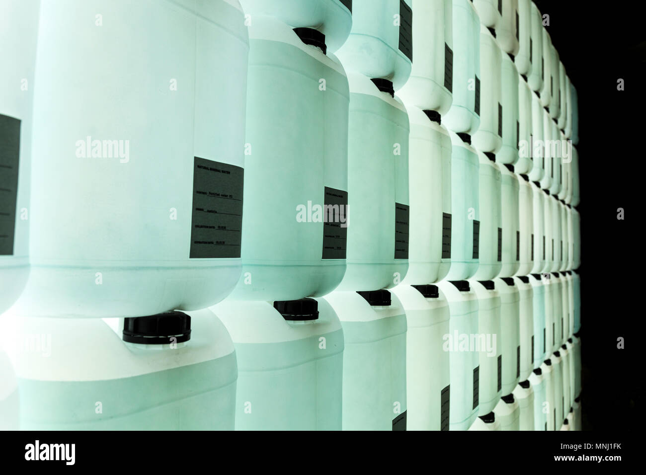 A wall of plastic translucent water canisters, chemicals, lab Stock ...