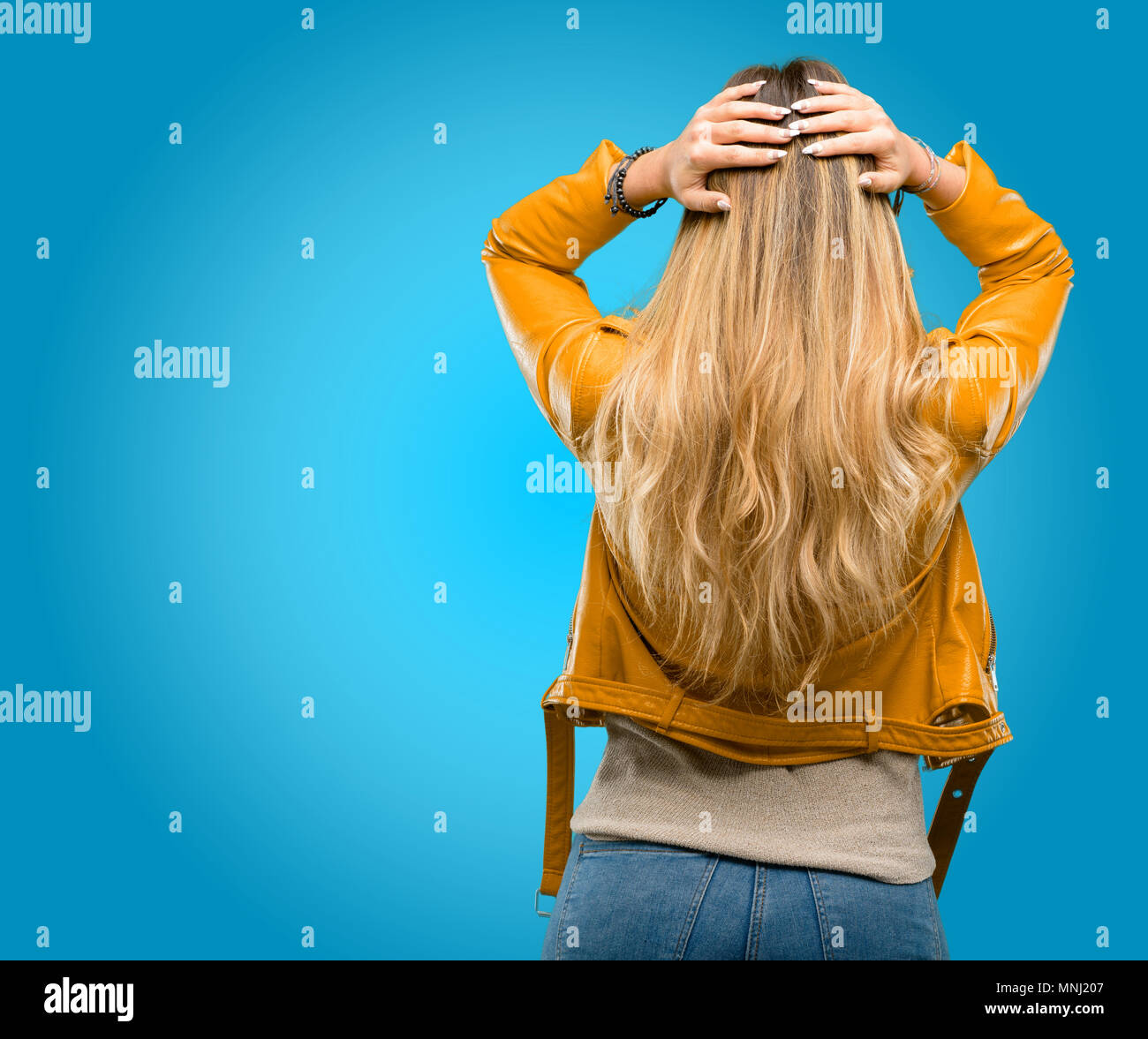 Beautiful young woman backside, rear view, blue background Stock Photo ...