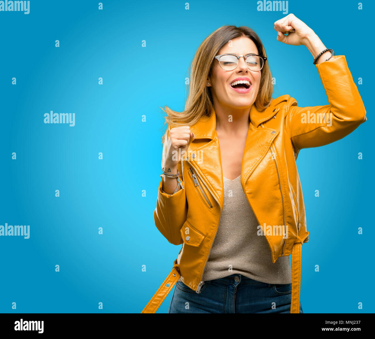 Beautiful young woman happy and excited expressing winning gesture ...