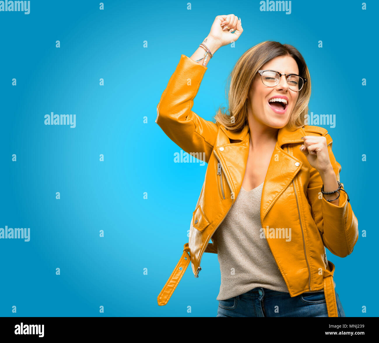 Beautiful young woman happy and excited expressing winning gesture ...