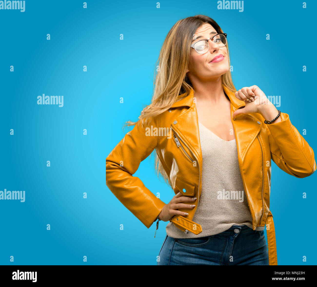 Beautiful young woman proud, excited and arrogant, pointing with ...