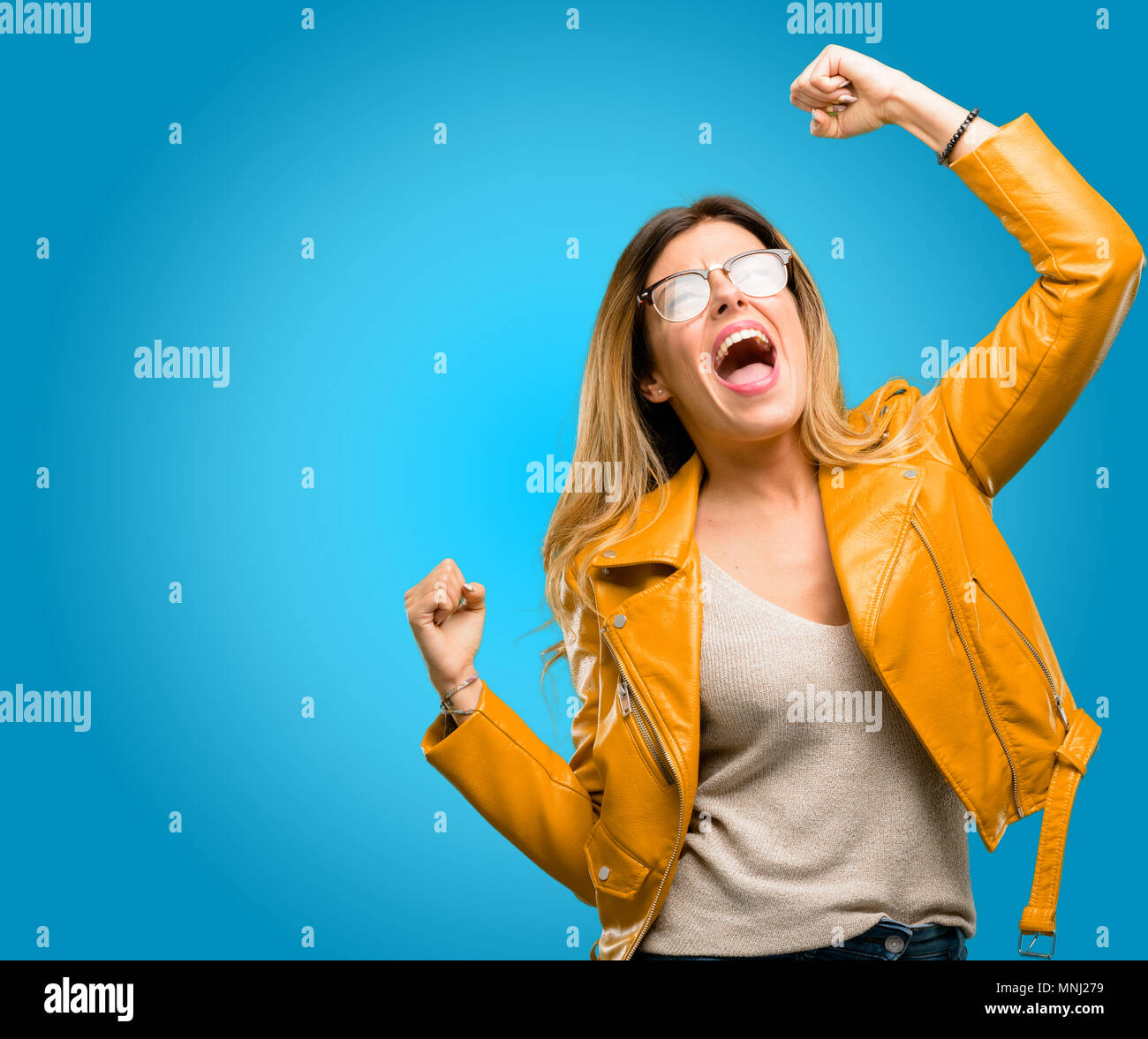 Beautiful young woman happy and excited celebrating victory expressing ...