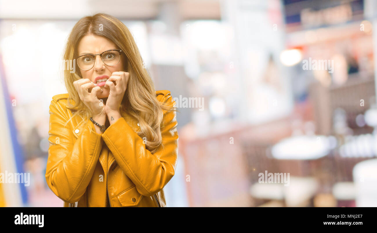 Beautiful young woman terrified and nervous expressing anxiety and ...