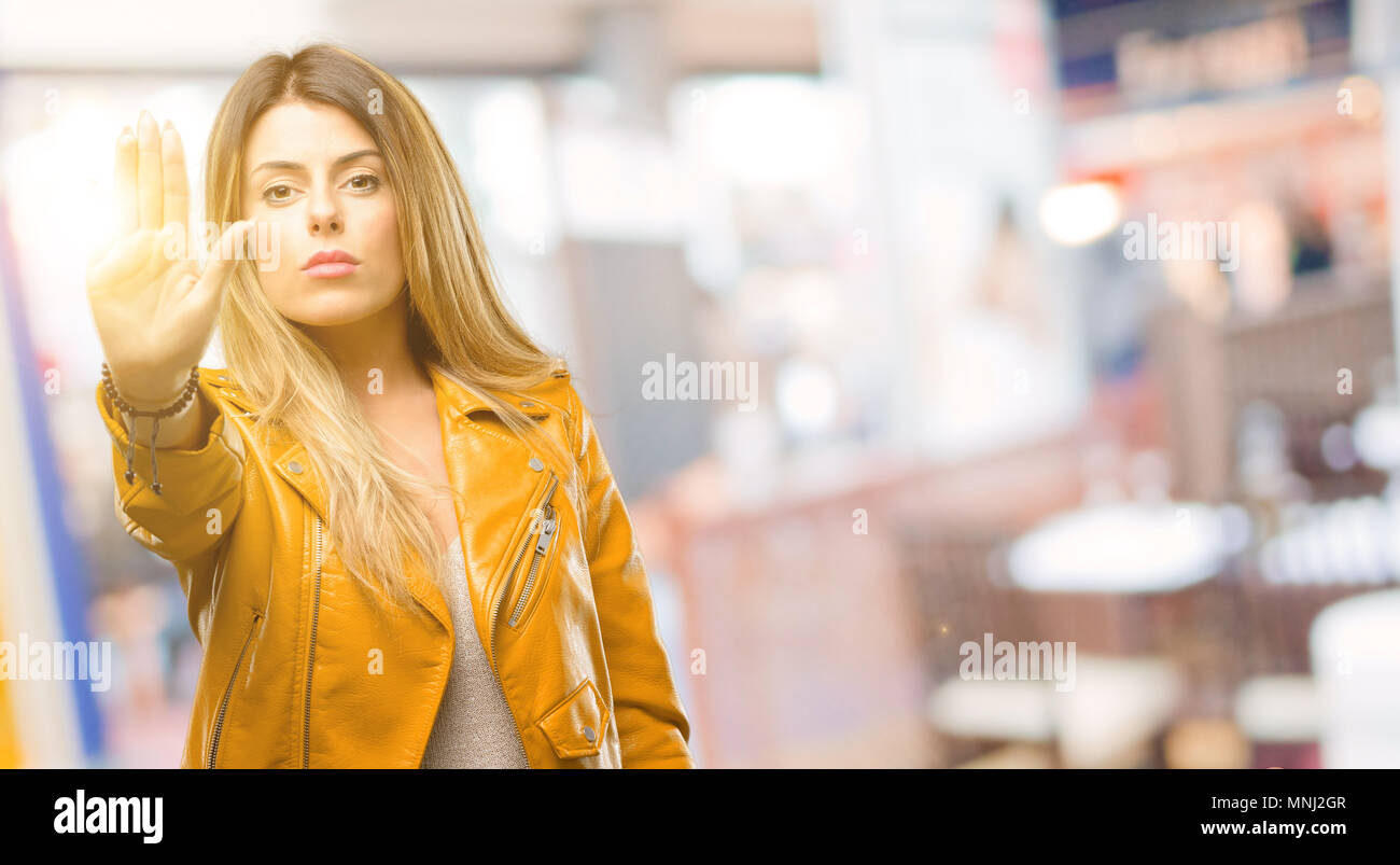 Beautiful young woman annoyed with bad attitude making stop sign with ...