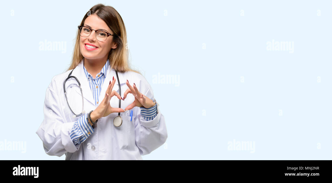 Young doctor woman, medical professional happy showing love with hands ...