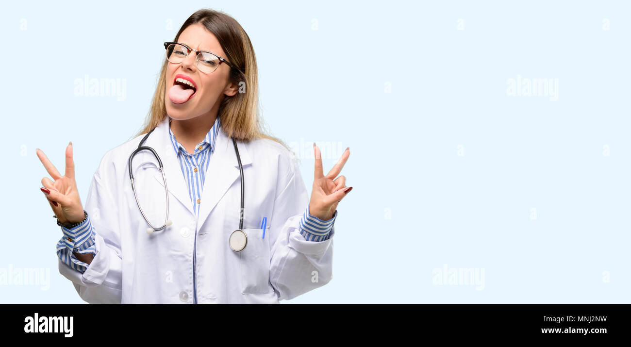 Young doctor woman, medical professional looking at camera showing tong ...