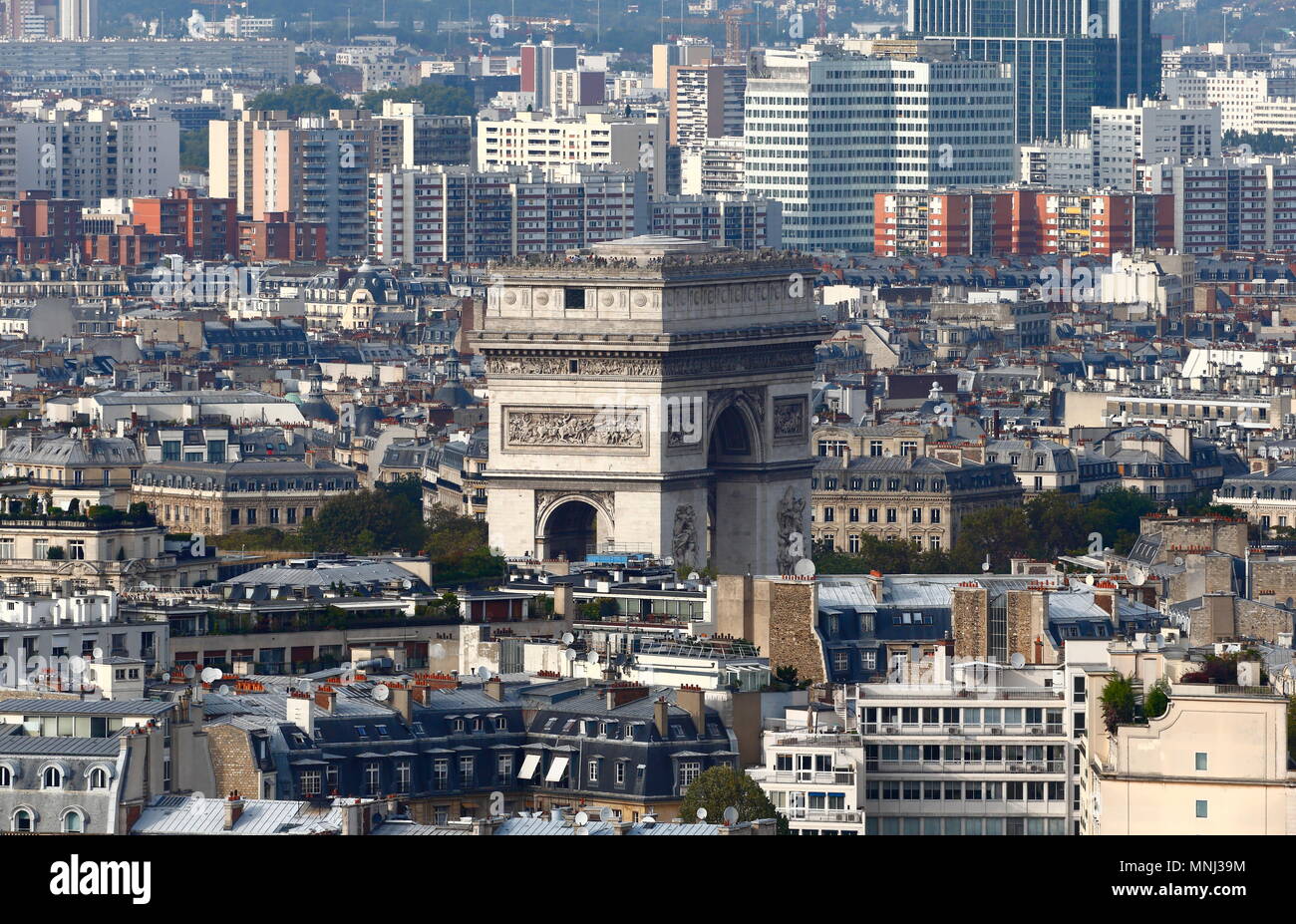 Arc de Triomphe, Commissioned by Napoleon in 1806, amid the rooftops of the Paris city skyline ...