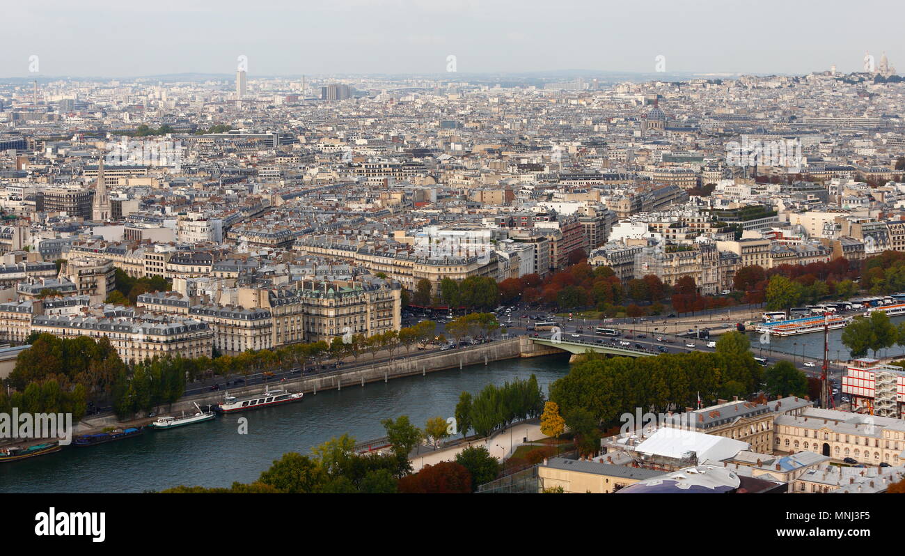 Paris city skyline viewed amid the rooftops across the Seine River from ...