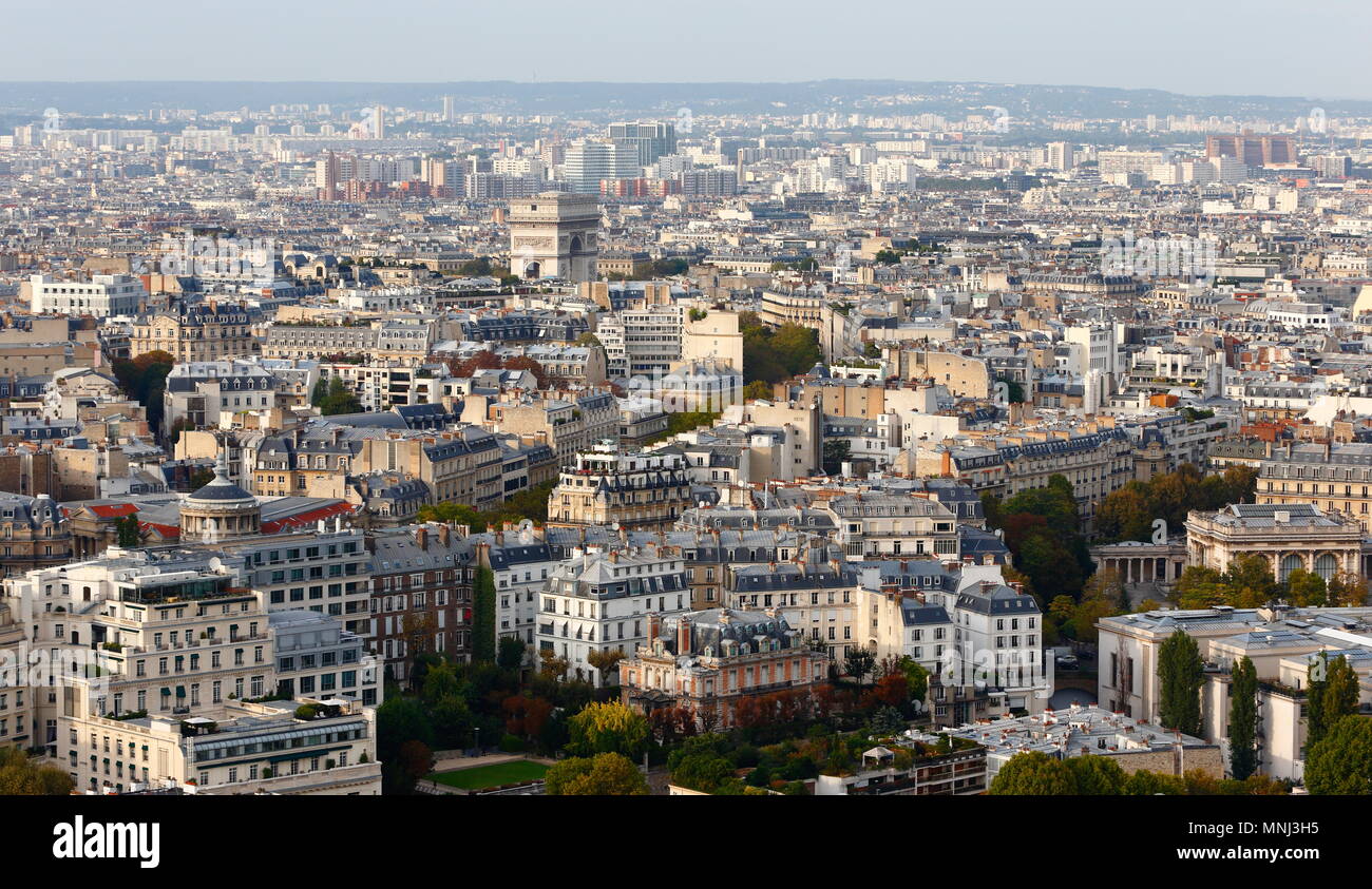 Arc de Triomphe, Commissioned by Napoleon in 1806, amid the rooftops of the Paris city skyline ...