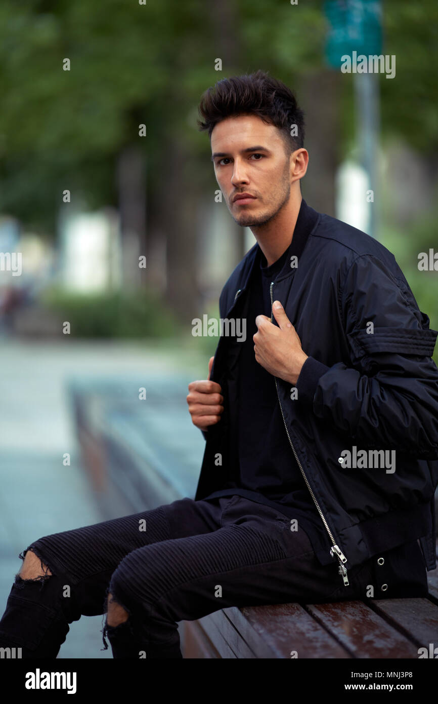Portrait of stylish man on night city background pose to camera Stock ...