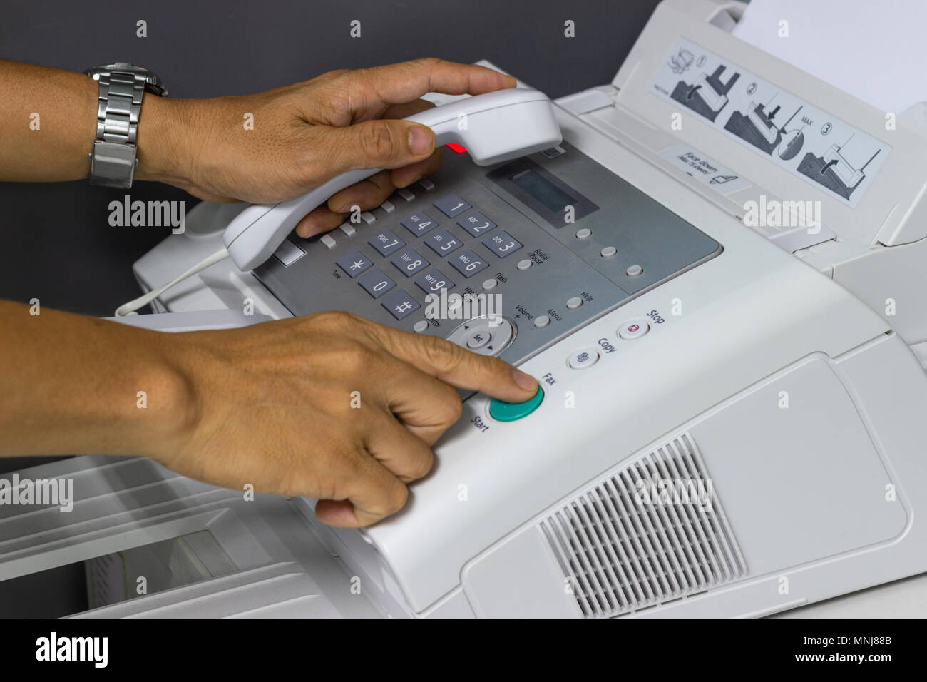 Hand man using fax machine hi-res stock photography and images - Alamy