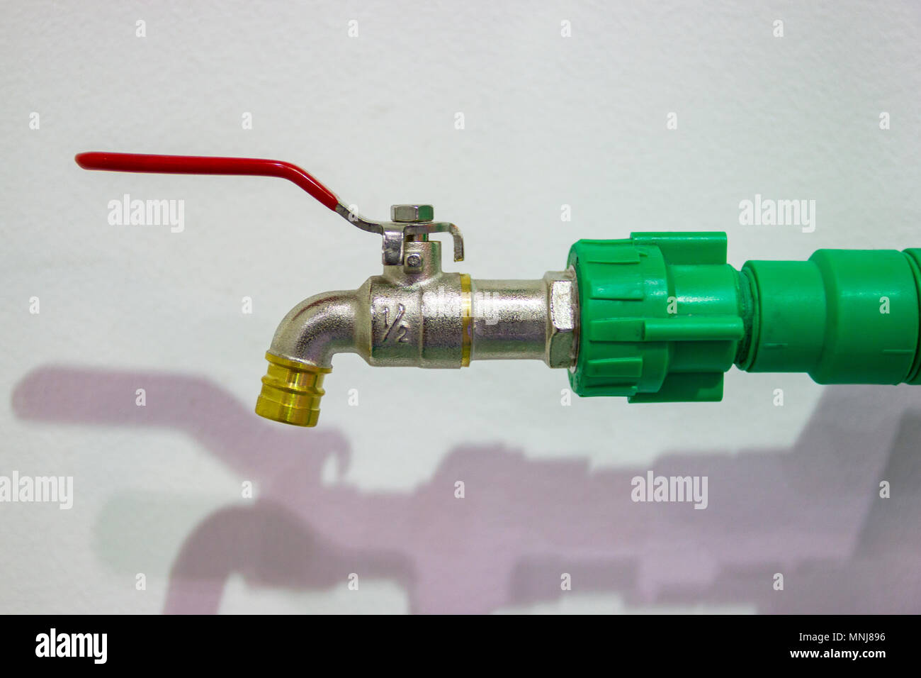 Red faucet and Green Pipes installed at home Stock Photo - Alamy