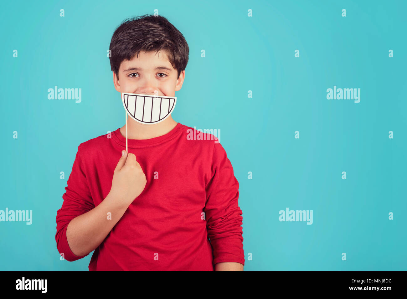 funny and smiling child on blue background Stock Photo - Alamy
