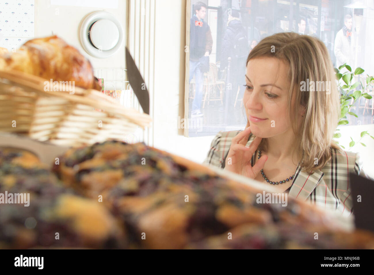 Kharkov, Ukraine, March 09, 2017: A young Slavic girl chooses pastries ...