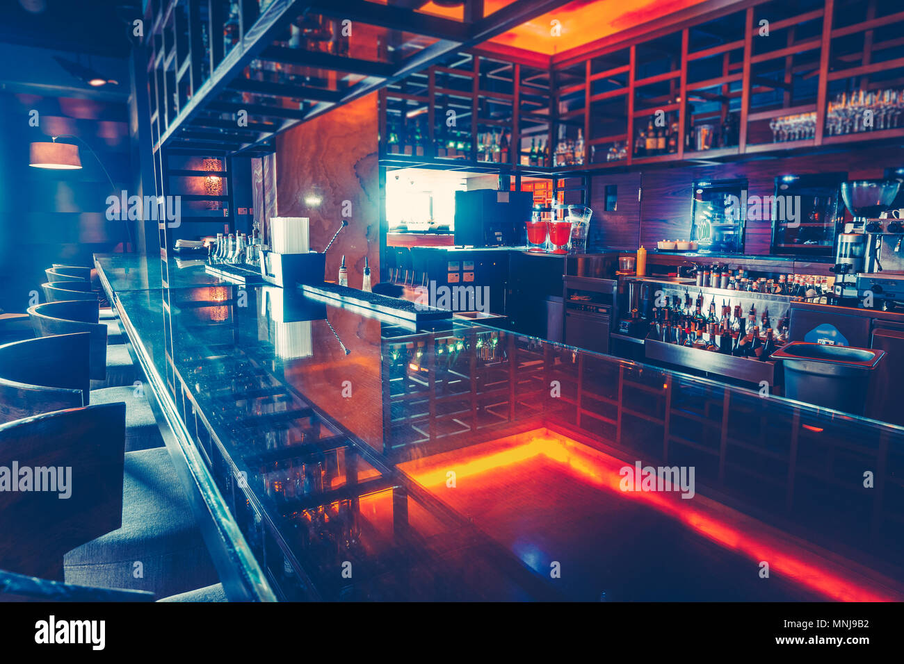 The close-up part of the modern bar counter with glass surface in the ...