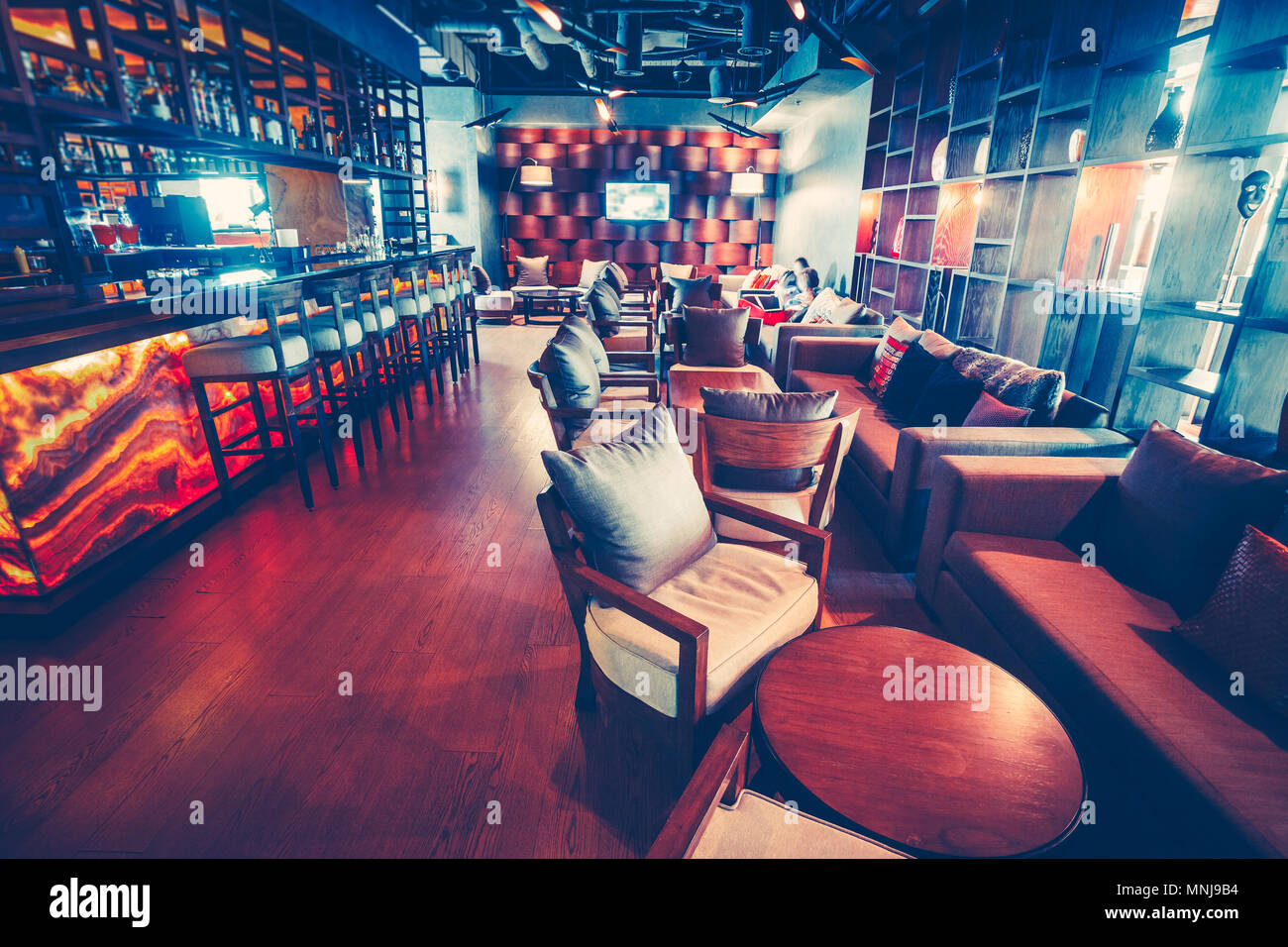 Stylish modern interior of the cozy restaurant in dark blue and red ...