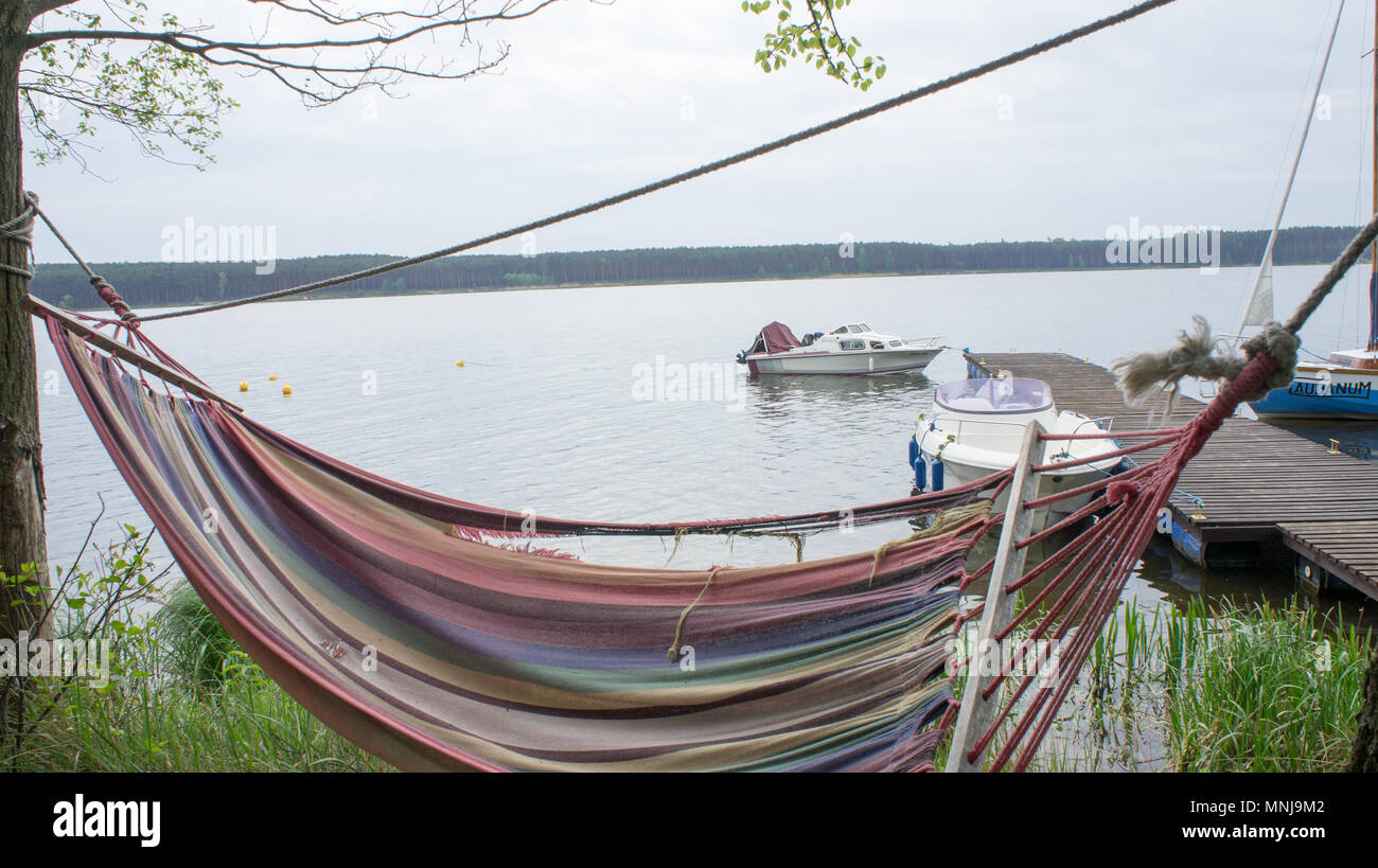 Hammock, lake and boats background Stock Photo - Alamy