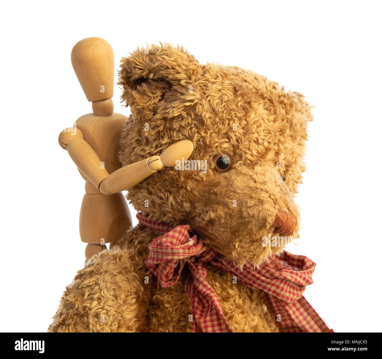 Wooden mannequin massaging a teddy bear who has a headache on a white ...