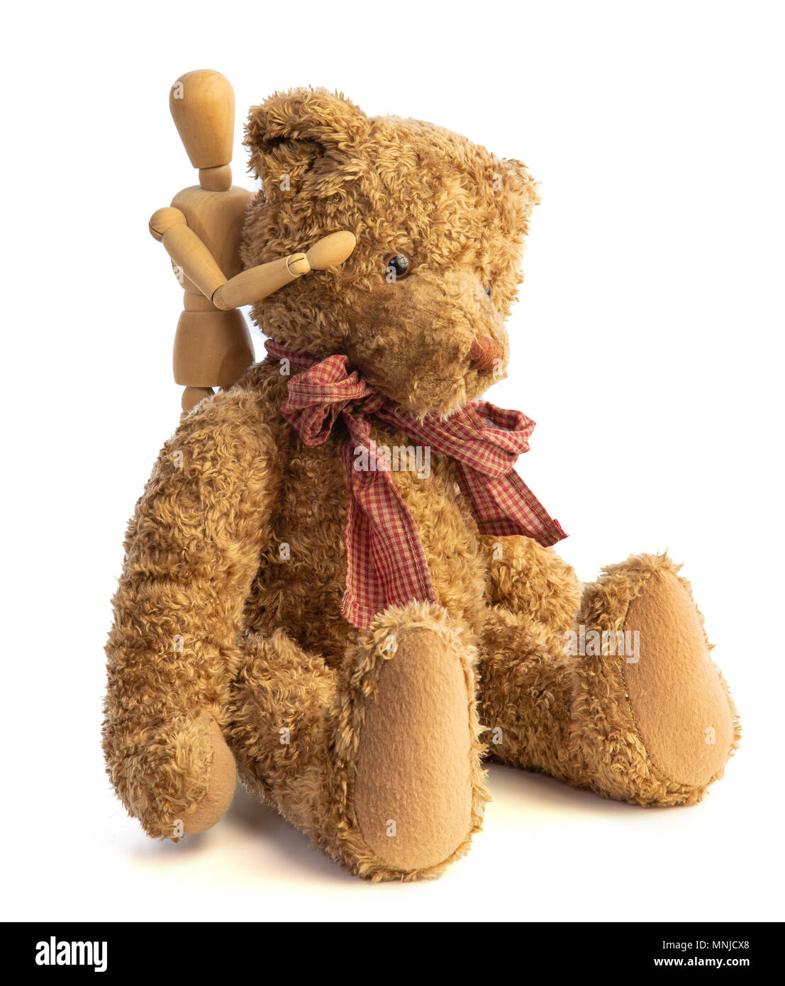 Wooden mannequin massaging a teddy bear who has a headache on a white ...